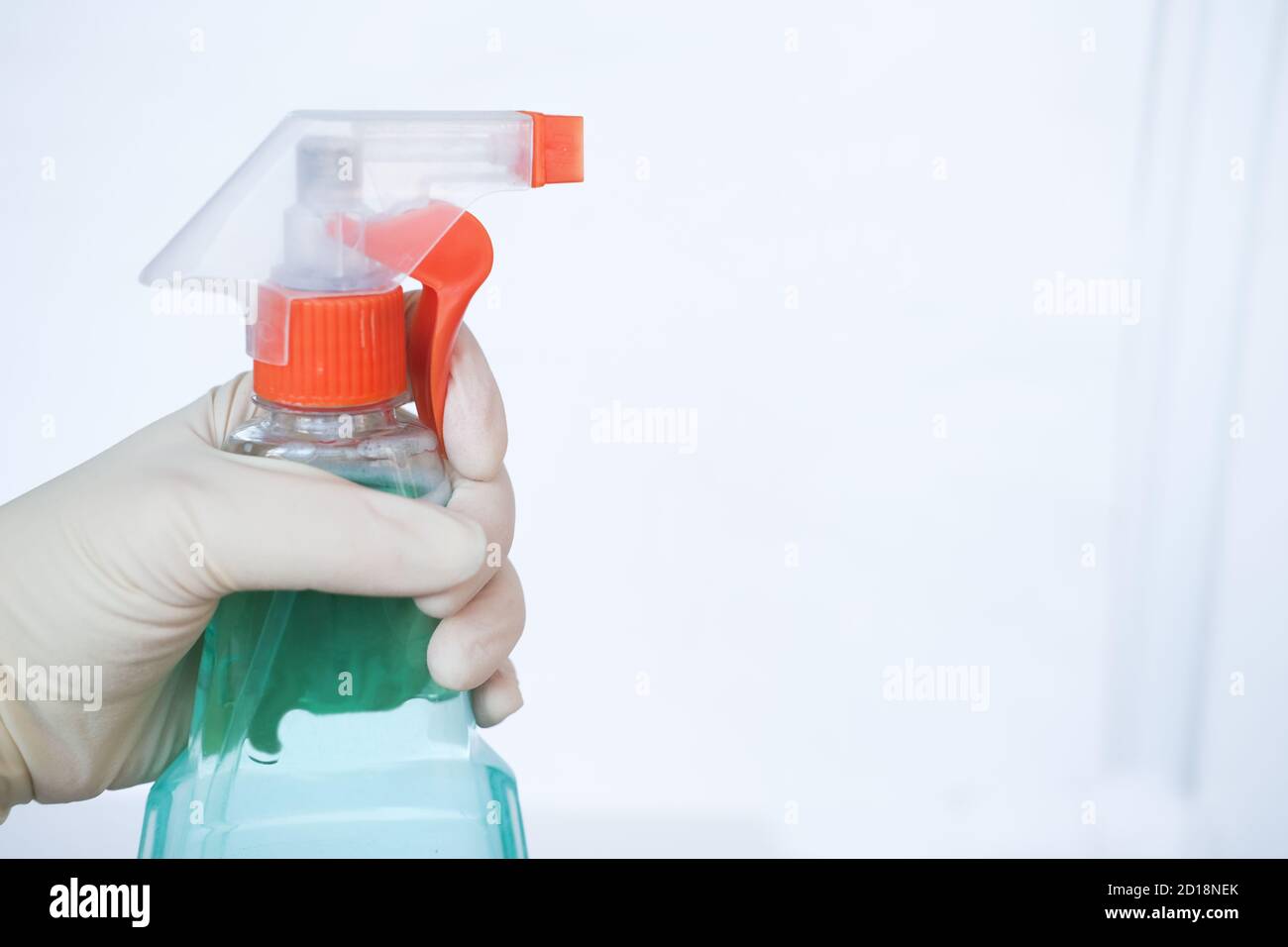 hand holding sprayer with detergent cleaning product. Home cleaning and ...