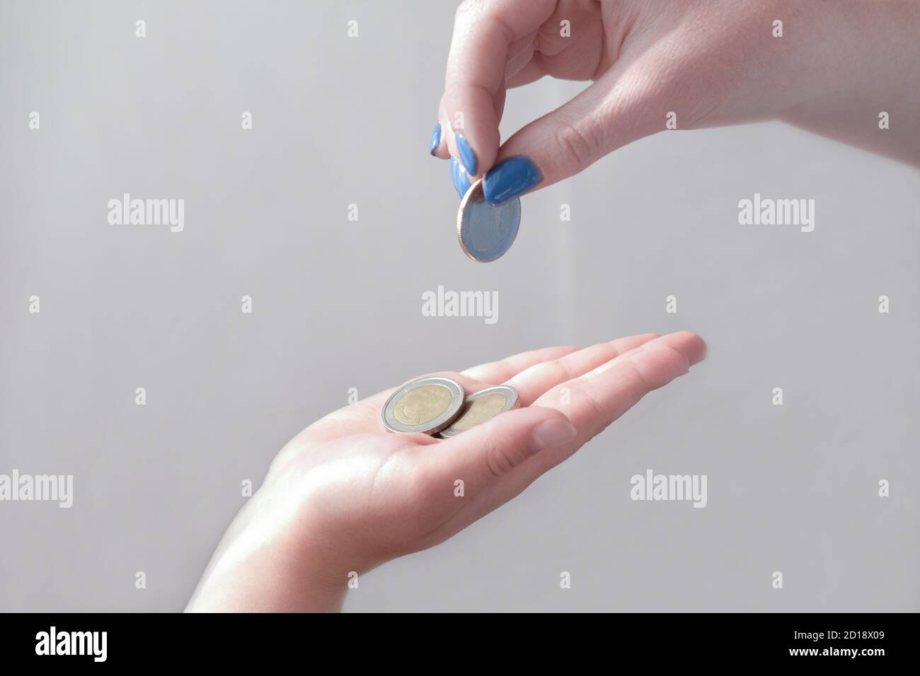 pocket money concept. woman's hand giving coins to a child. money for ...