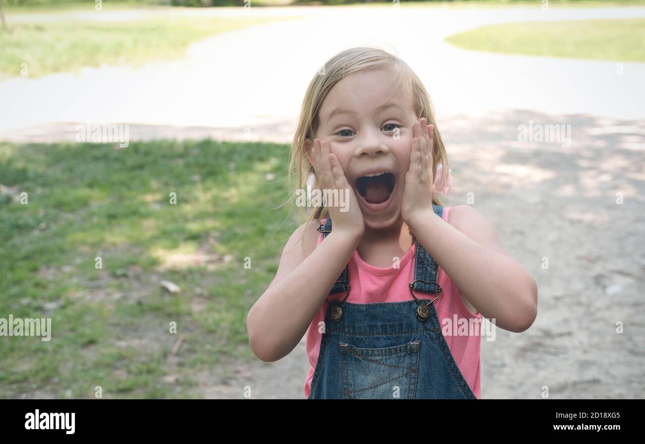 little excited girl making wow gesture. blonde caucasian girl ...