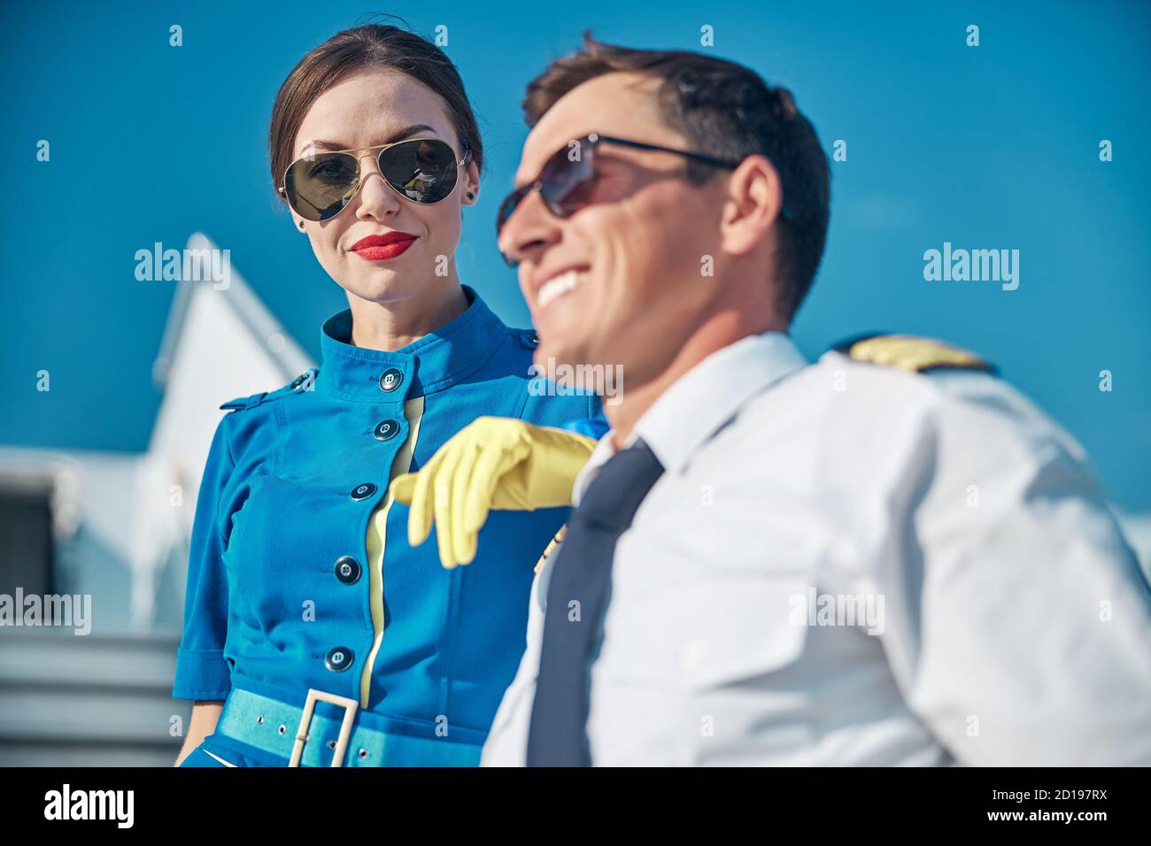 Happy stewardess and pilot enjoying work together Stock Photo - Alamy
