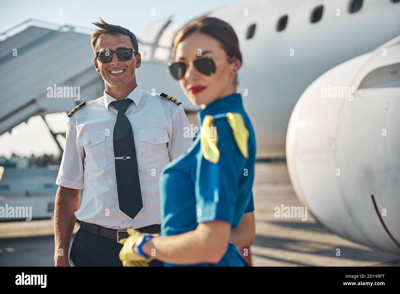 Happy attractive young crew before boarding outdoors Stock Photo - Alamy