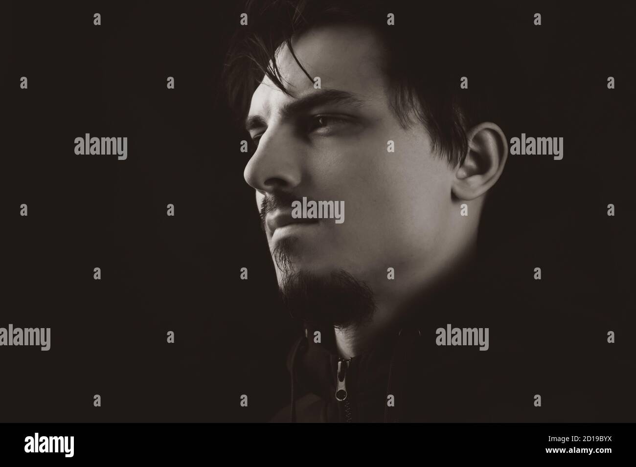 Male portrait. young man in the dark. monochrome color Stock Photo - Alamy