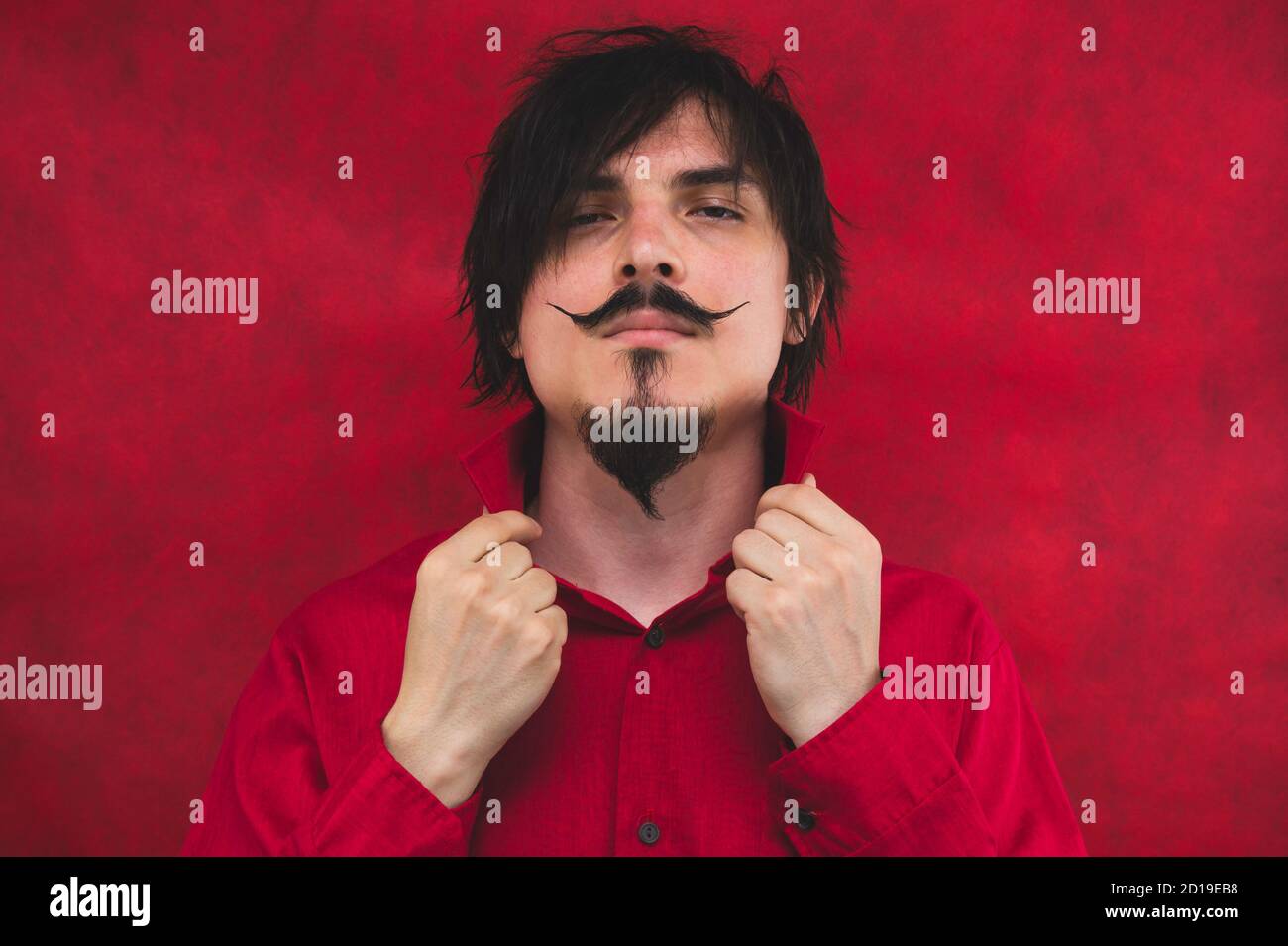 Male portrait. young man in red shirt on the red background Stock Photo ...