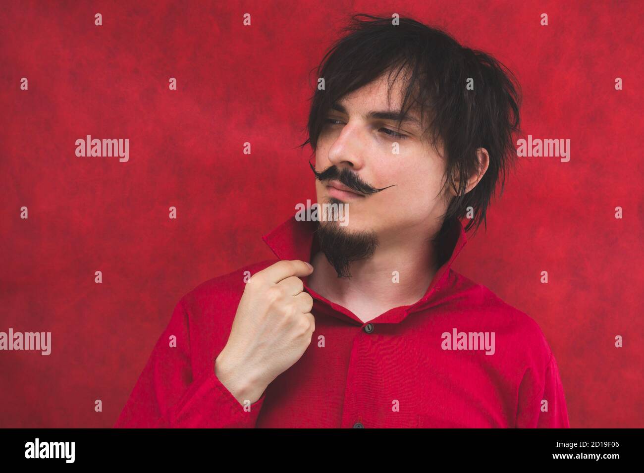 Male portrait. young man in red shirt on the red background Stock Photo ...