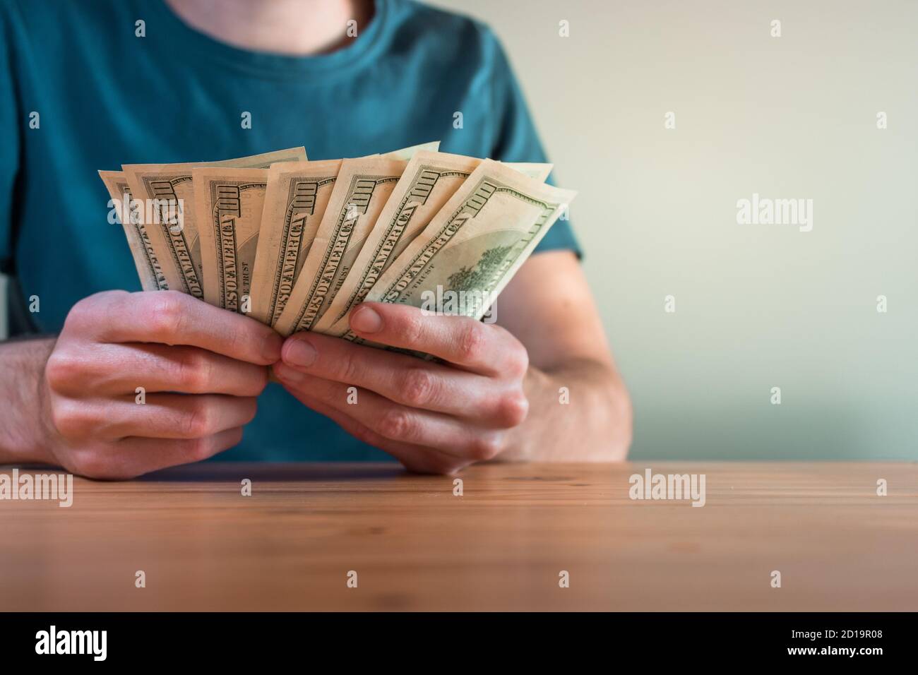 Person counting US dollar bills Stock Photo - Alamy