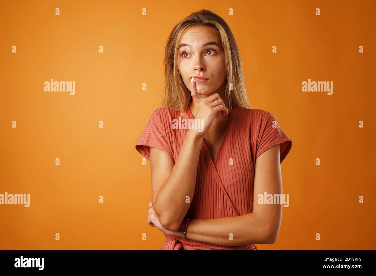 Studio portrait of beautiful young casual woman thinking Stock Photo ...