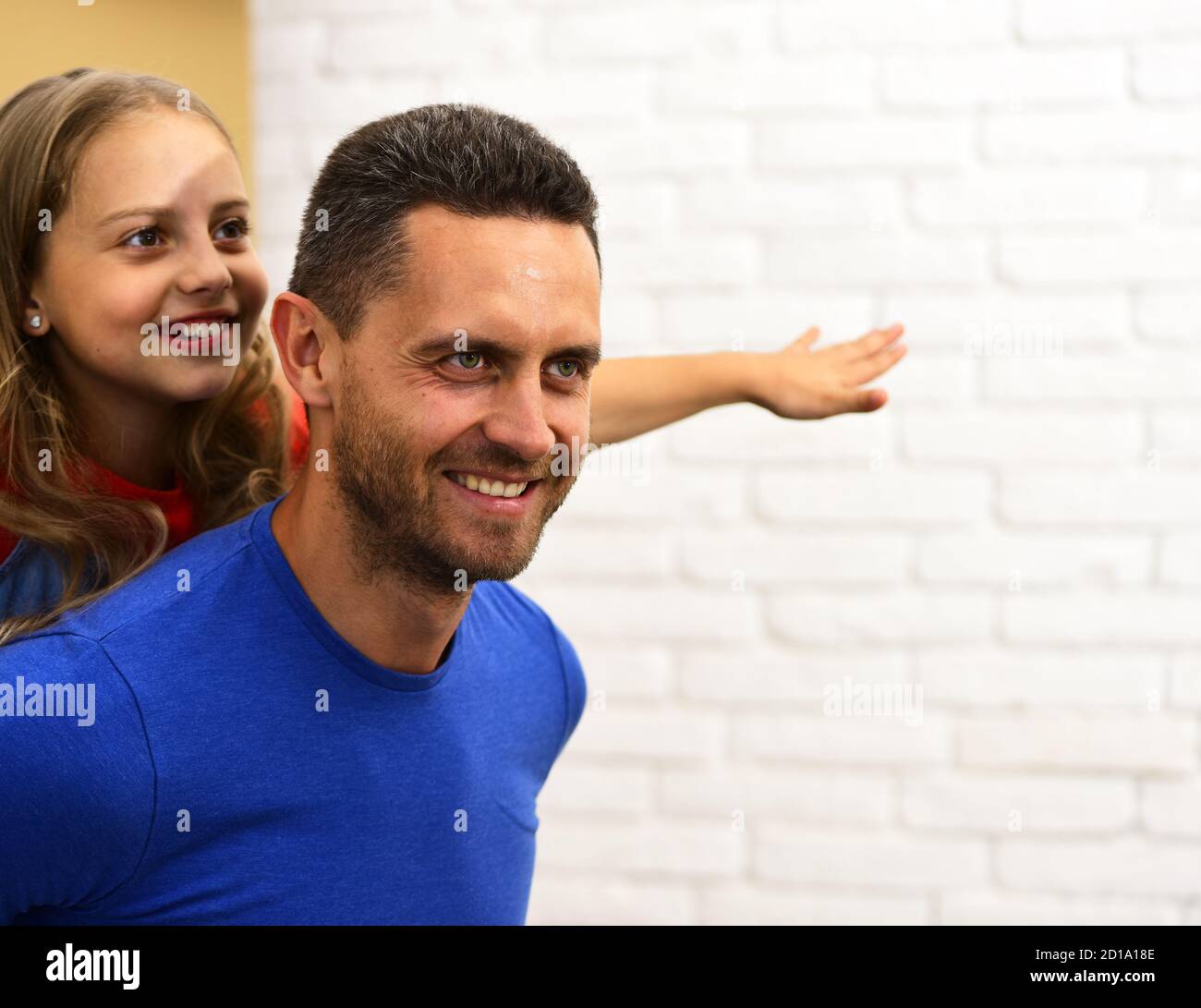 Childhood and family time concept. Man and girl pretend to fly on white ...