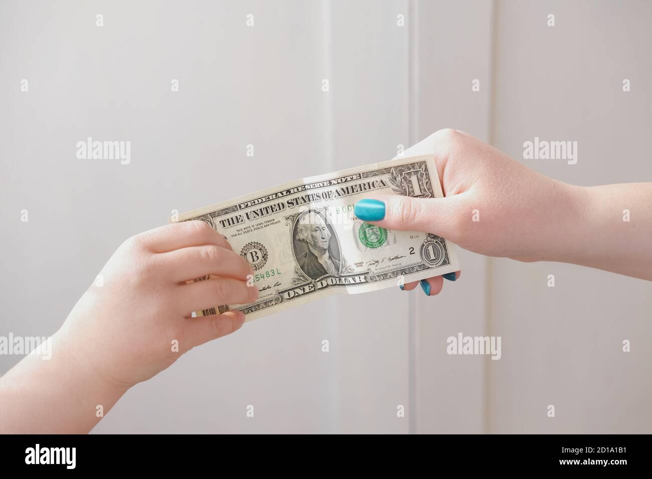pocket money concept. woman's hand giving dollar note to a child. money ...