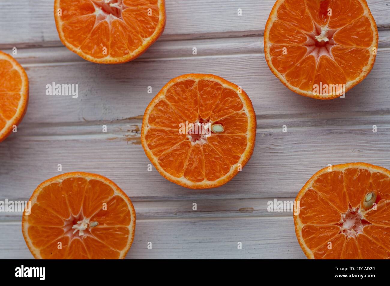 Half mandarin pieces on a flat surface Stock Photo - Alamy