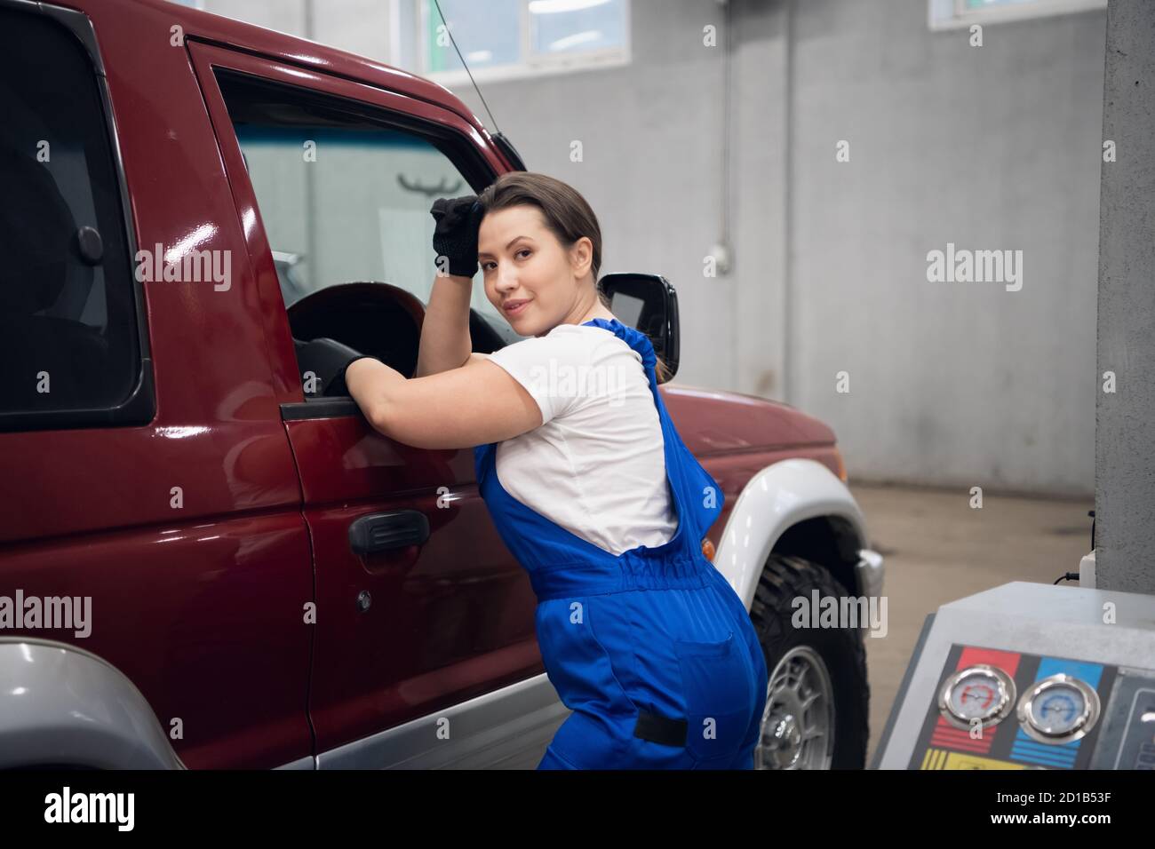 Woman in overalls in garage hi-res stock photography and images - Alamy