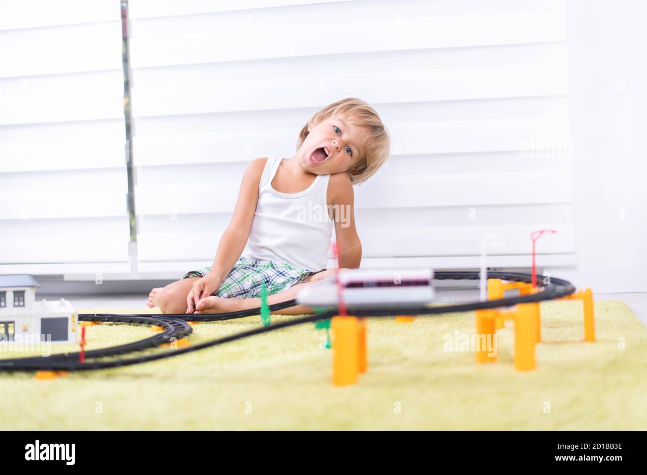 Little boy play with plastic railway. Child with toy train. Educational ...