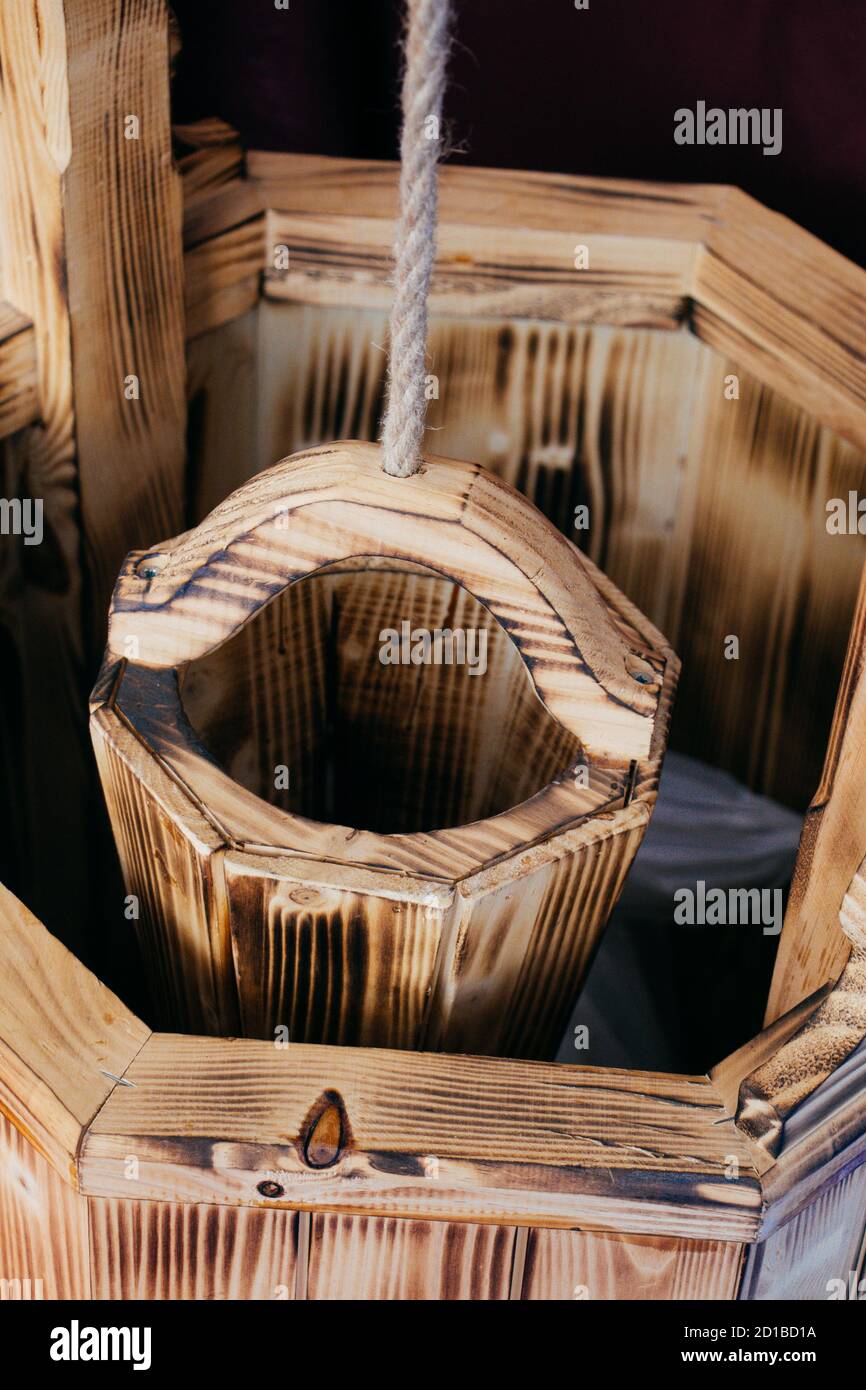 Vertical shot of a small wooden well with a blurry background Stock ...