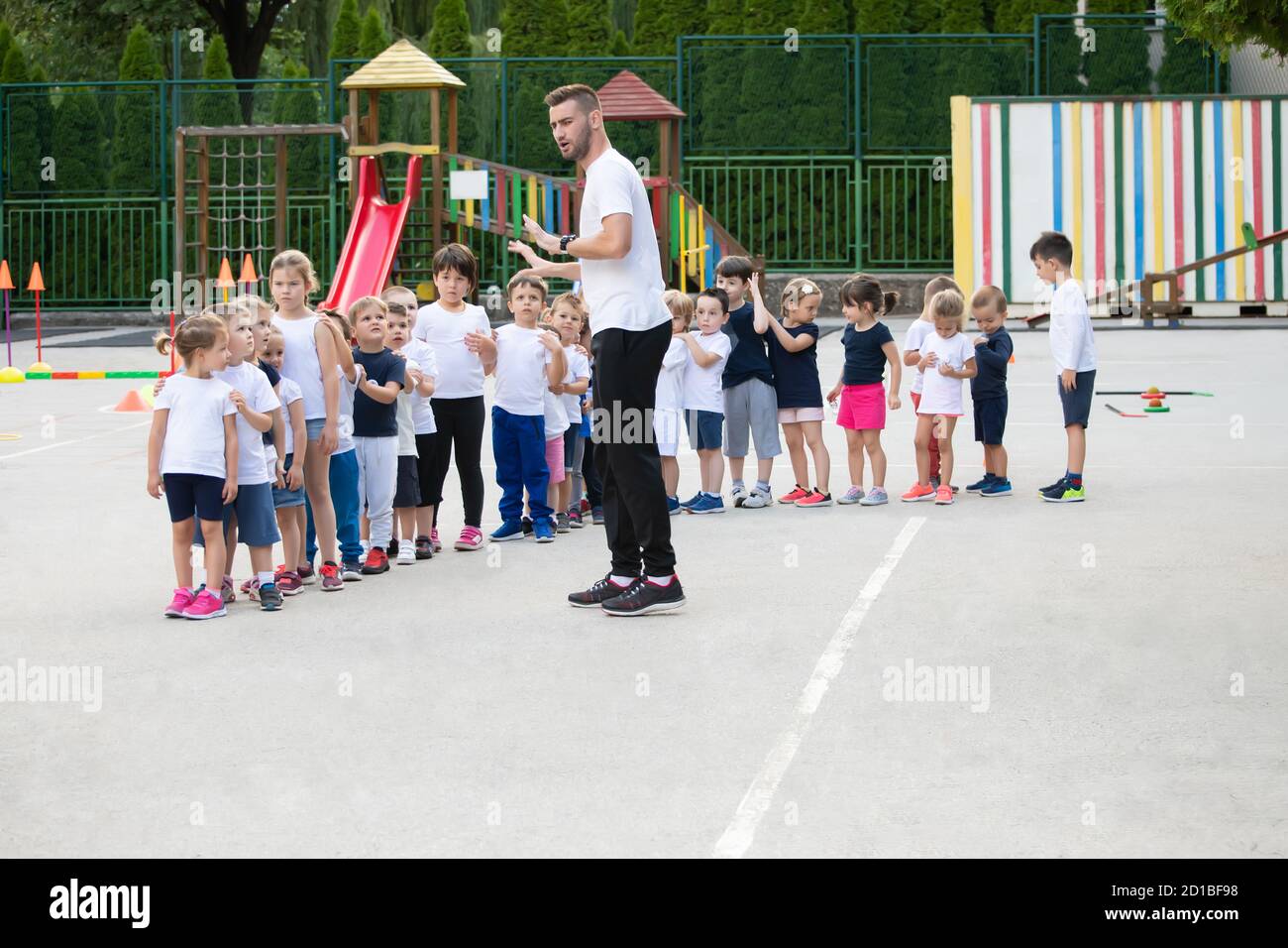 Group of children standing in column and waiting for lesson start ...