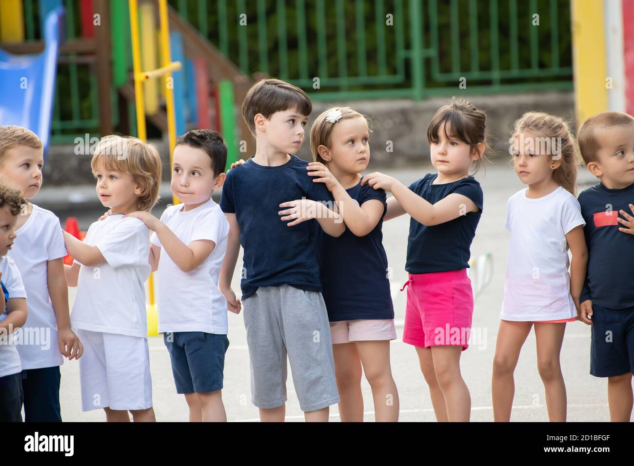 Close up of children group standing in column and waiting for lesson ...