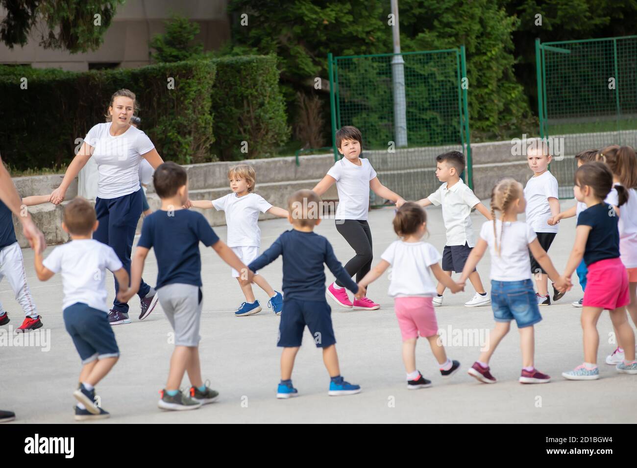Group of children warming up and preparing for the main part of lesson ...