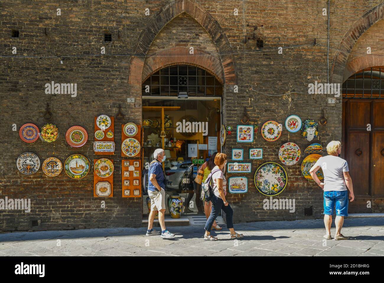 Exterior of a handmade ceramics shop with decorated plates hanging on ...