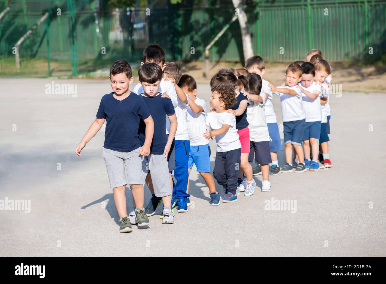 Group of children standing in column and waiting for lesson start ...