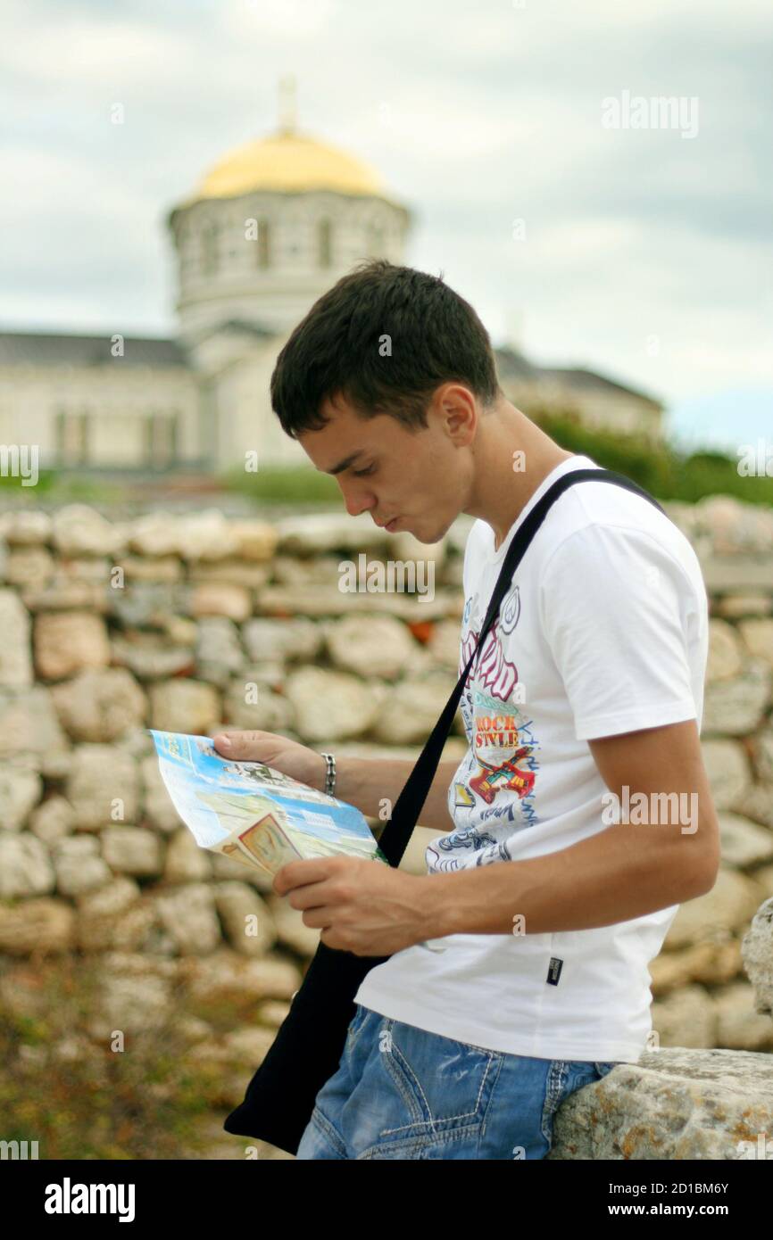 The guy looks at the map guide Stock Photo - Alamy