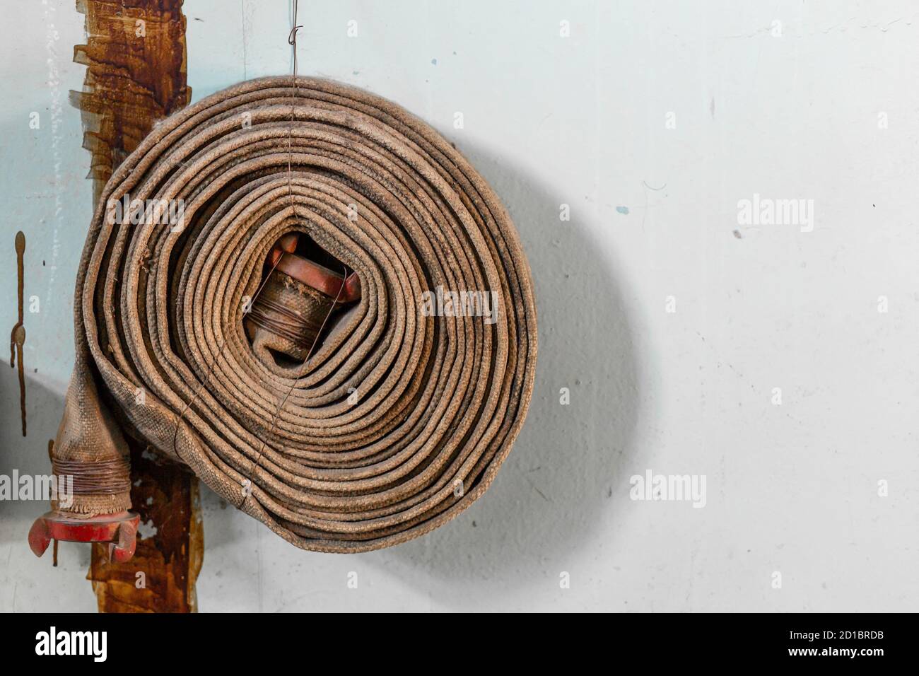 Twisted old rusty fire hydrant hose. Poor fire safety in the building ...