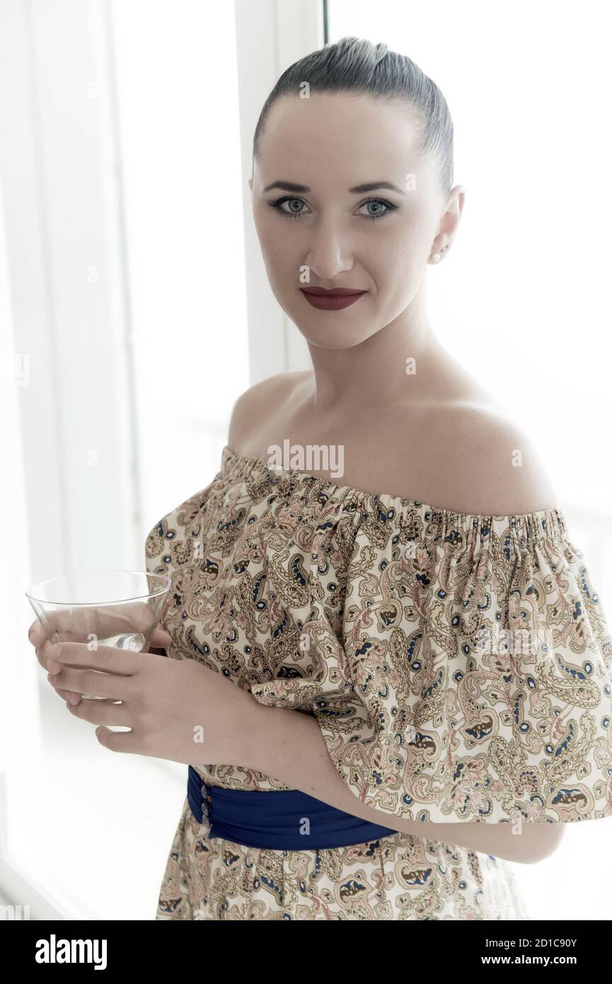 Welcome drink. Woman makeup face hold glass alcohol cocktail. Girl at ...