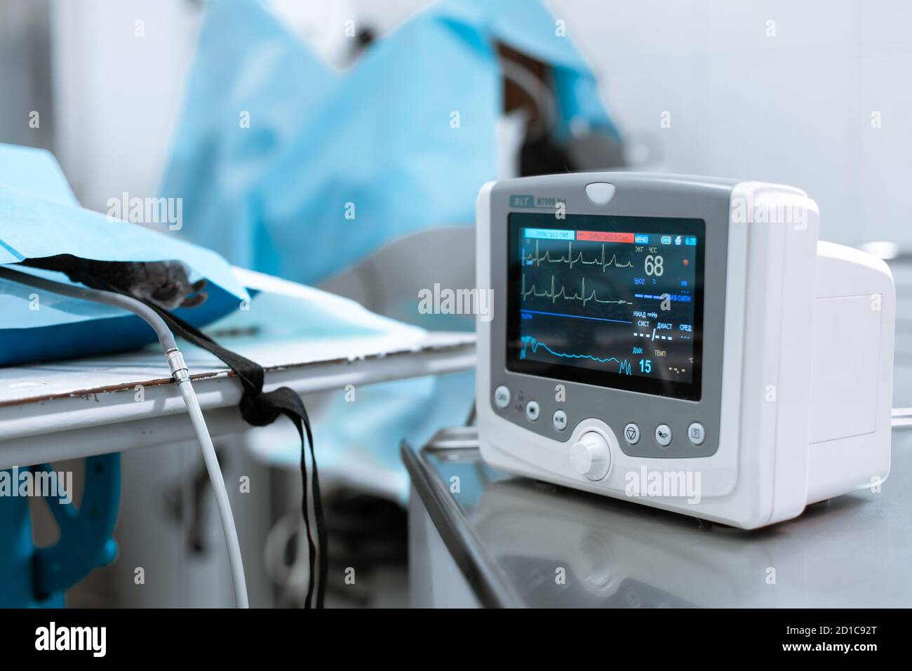 Cardiac monitor at operating table with dog on background. Pet surgery ...