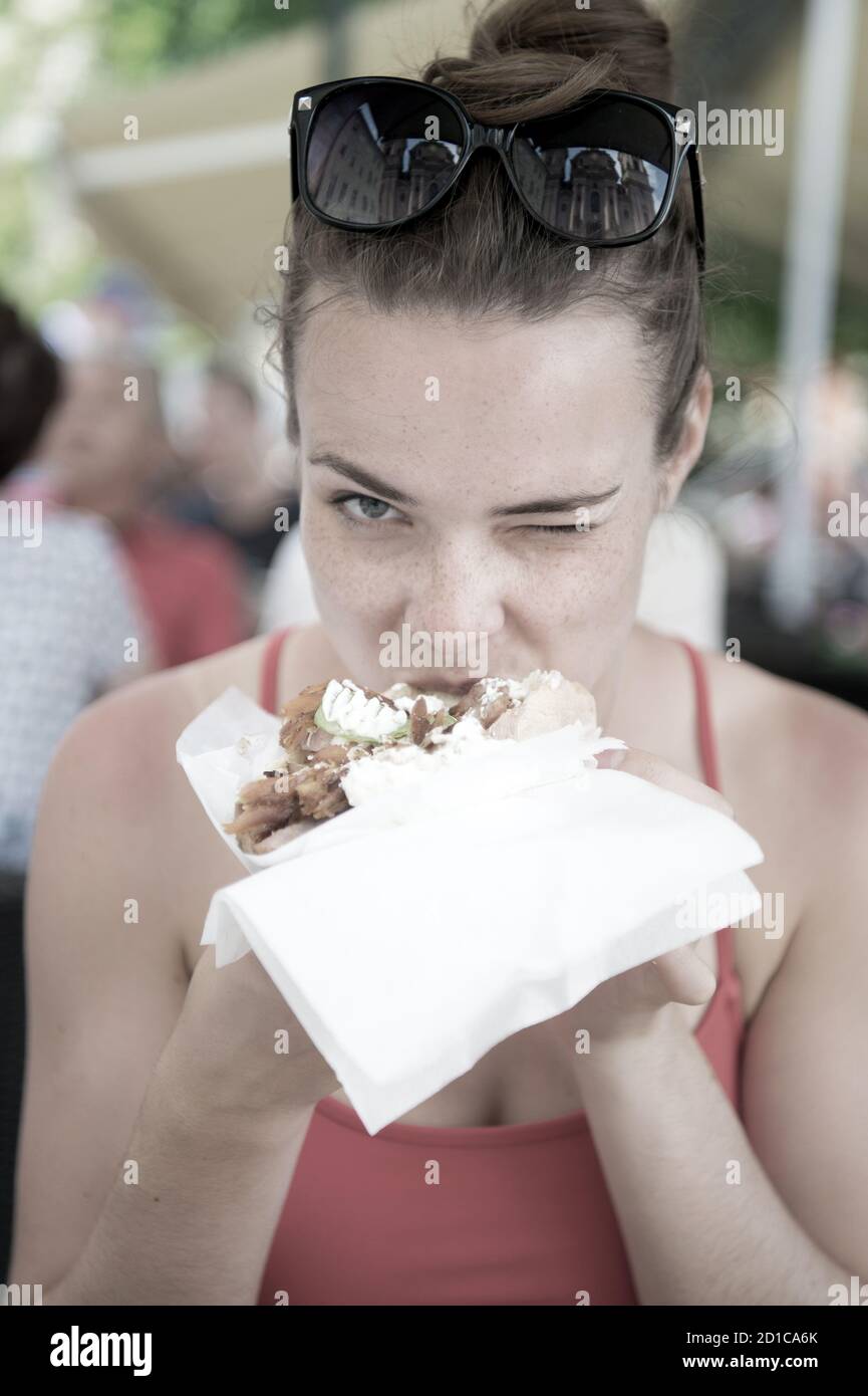 pretty girl or Woman eating sandwich gyros. Girl with pleasure eats ...