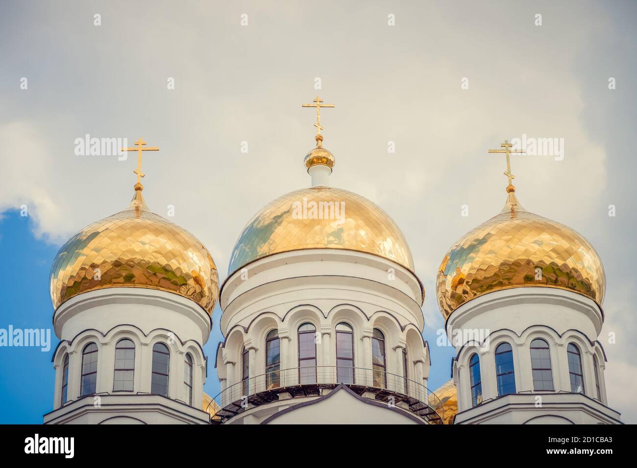 Golden domes, cupolas with Eastern Orthodox crosses on a white Church ...