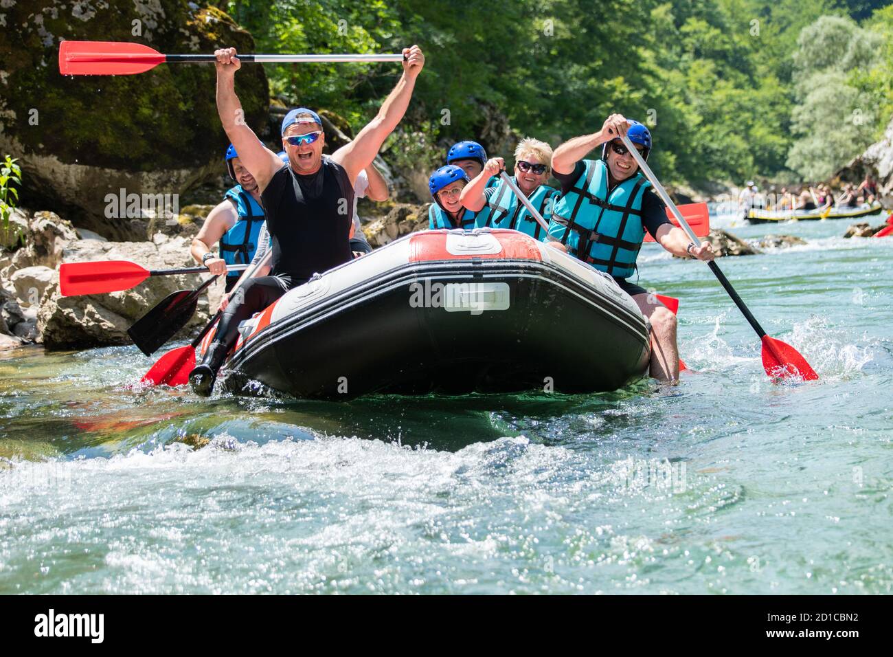Rafting team goes down the river on the beautiful sunny day ...