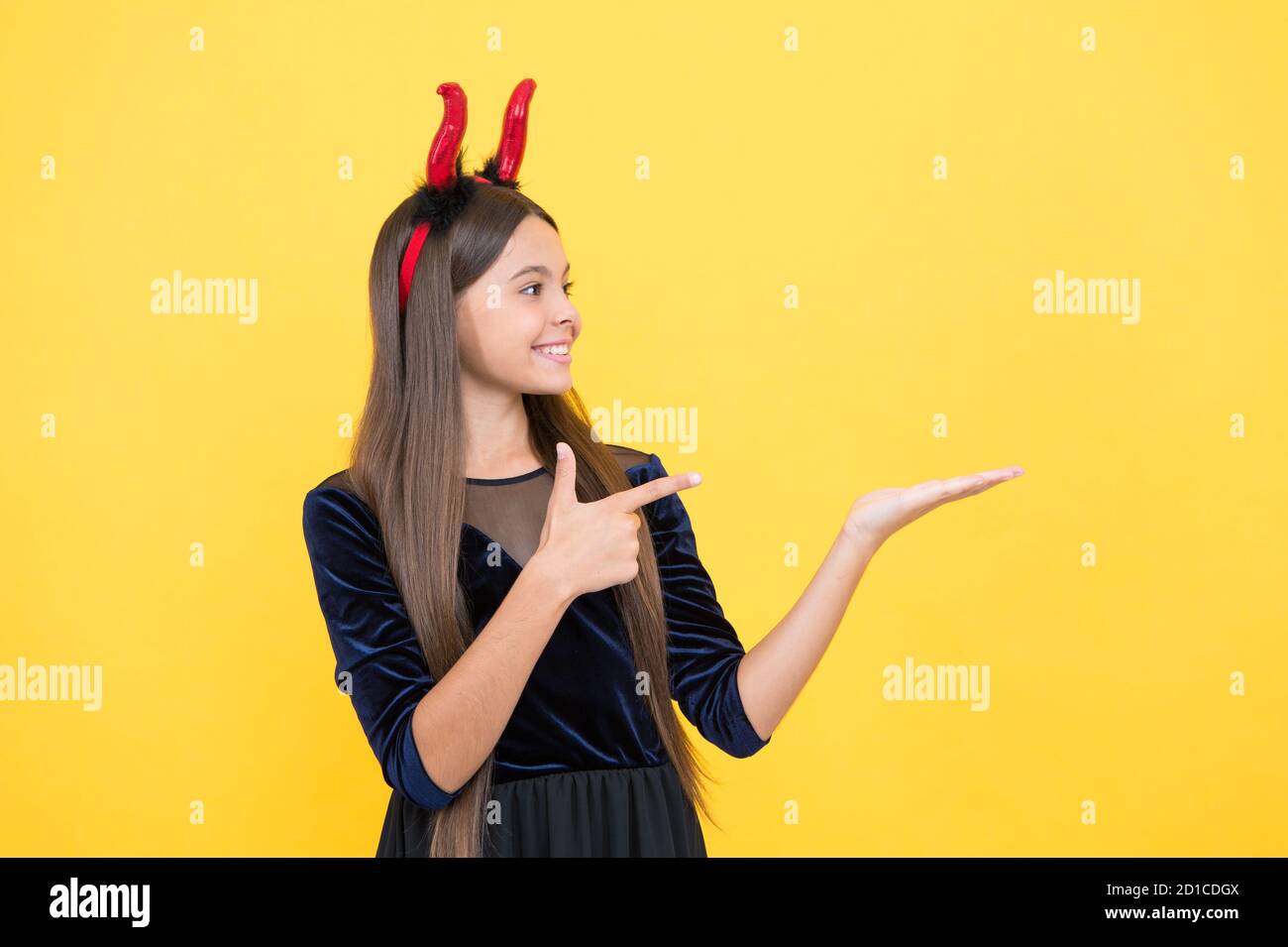 happy witch teenage devil girl pointing finger on copy space wear imp ...