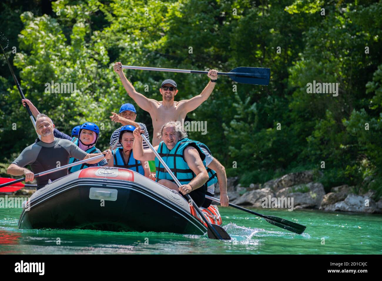Rafting team goes down the river on the beautiful sunny day ...