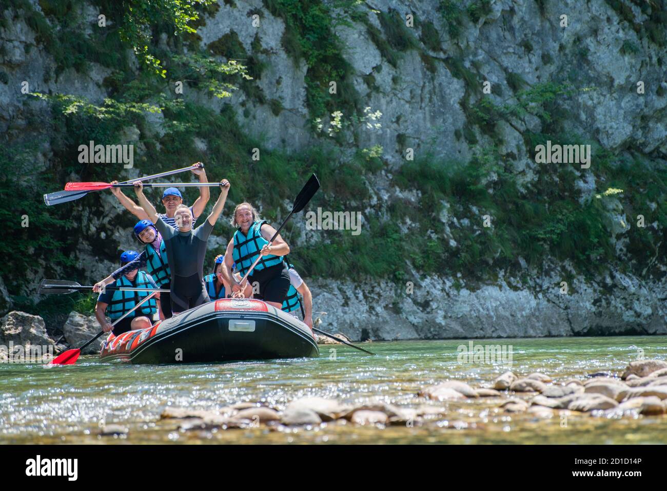 Rafting team goes down the river on the beautiful sunny day ...