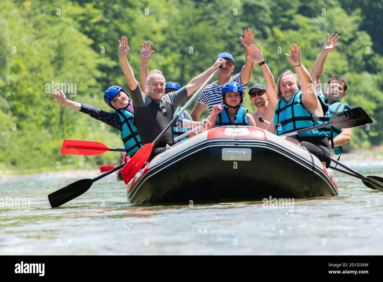 Rafting team goes down the river on the beautiful sunny day ...