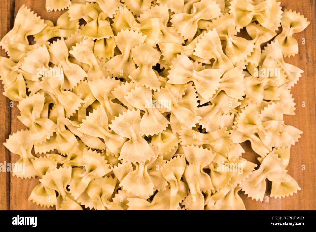 Typical Italian cuisine. Dry Butterfly Pasta with Basil. Top view. Copy ...