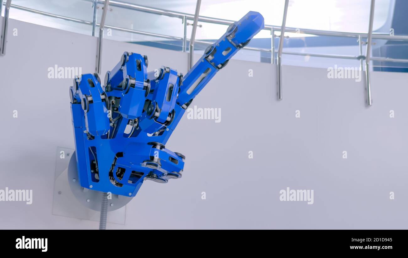Futuristic big blue mechanical robotic hand with remote control moving ...