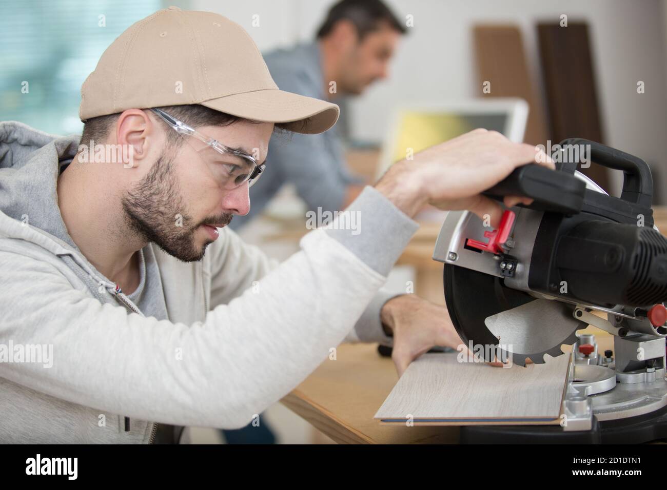 carpenter cutting a piece of wood with a carpentry machine Stock Photo ...