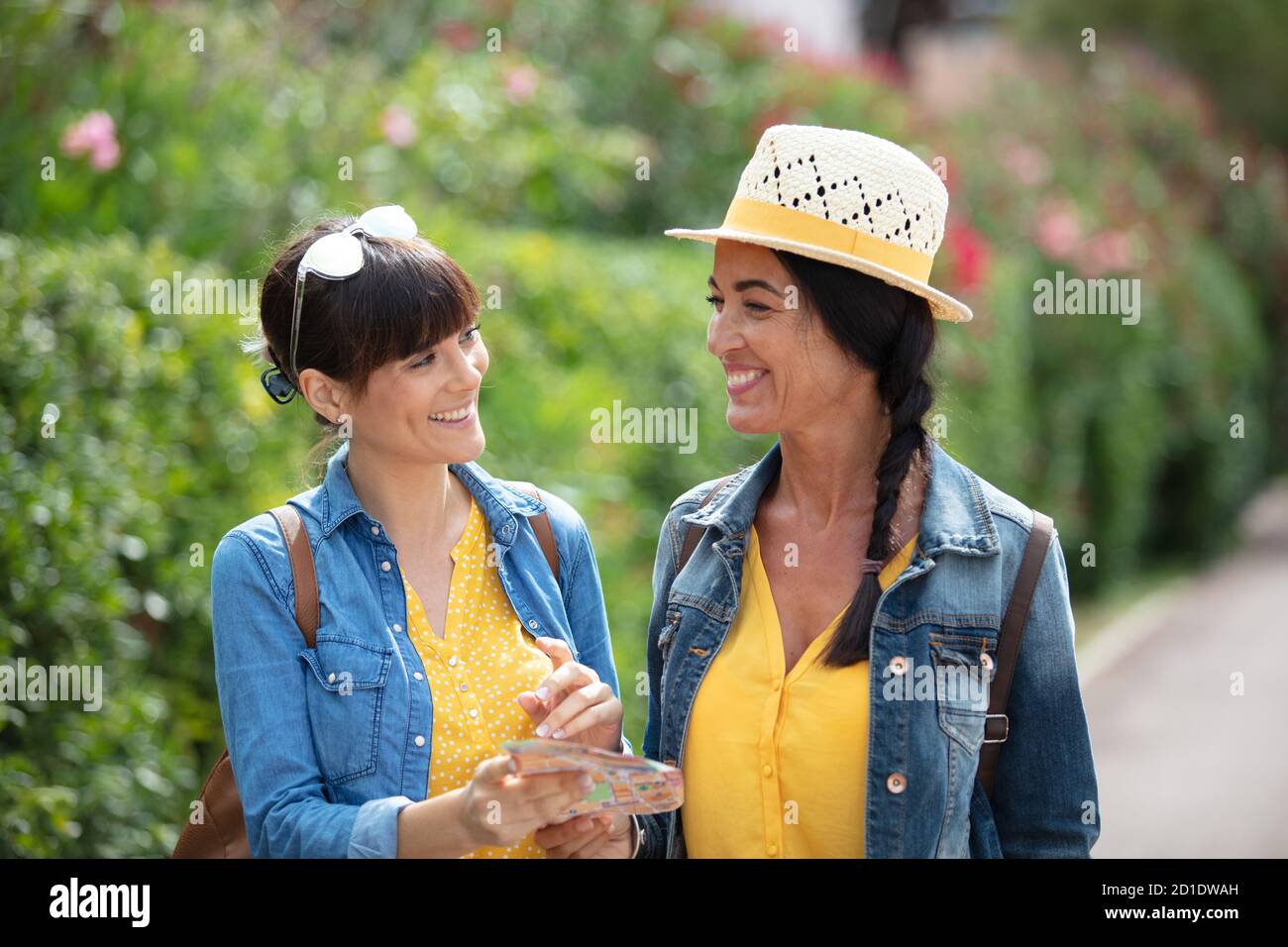 two friends walking together in a park Stock Photo - Alamy