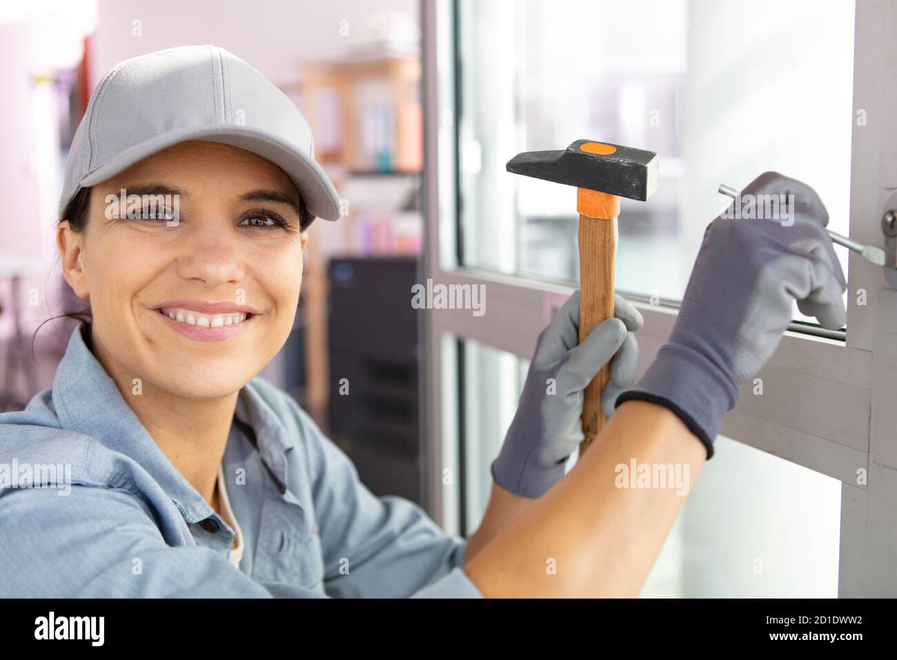 Woman locksmith fixing lock hi-res stock photography and images - Alamy