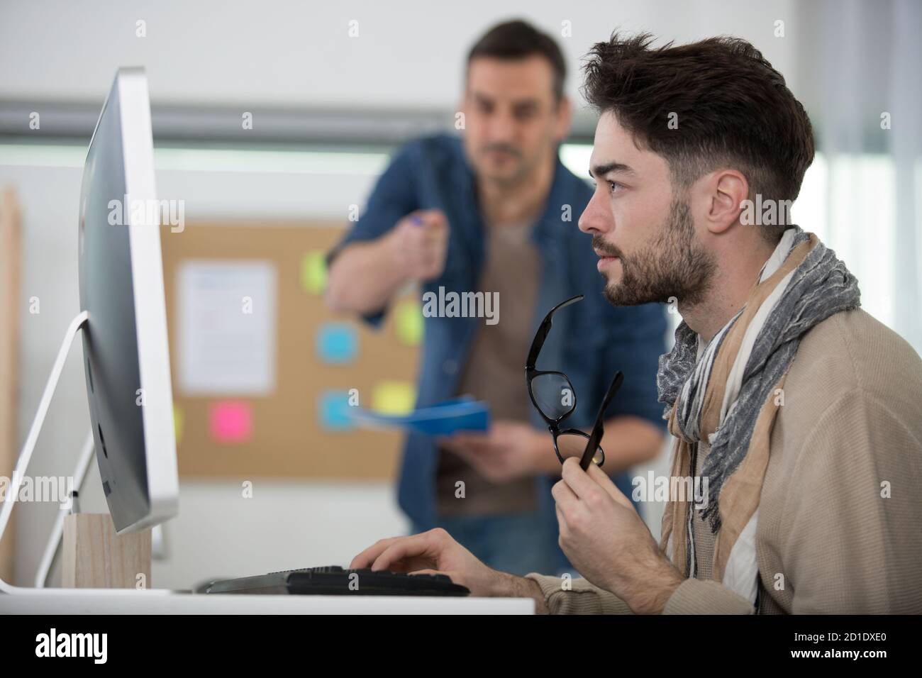 Frowning man sitting office thinking hi-res stock photography and ...