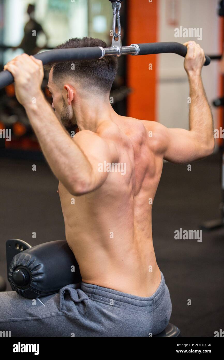 man pulling up on horizontal bar in a gym Stock Photo - Alamy