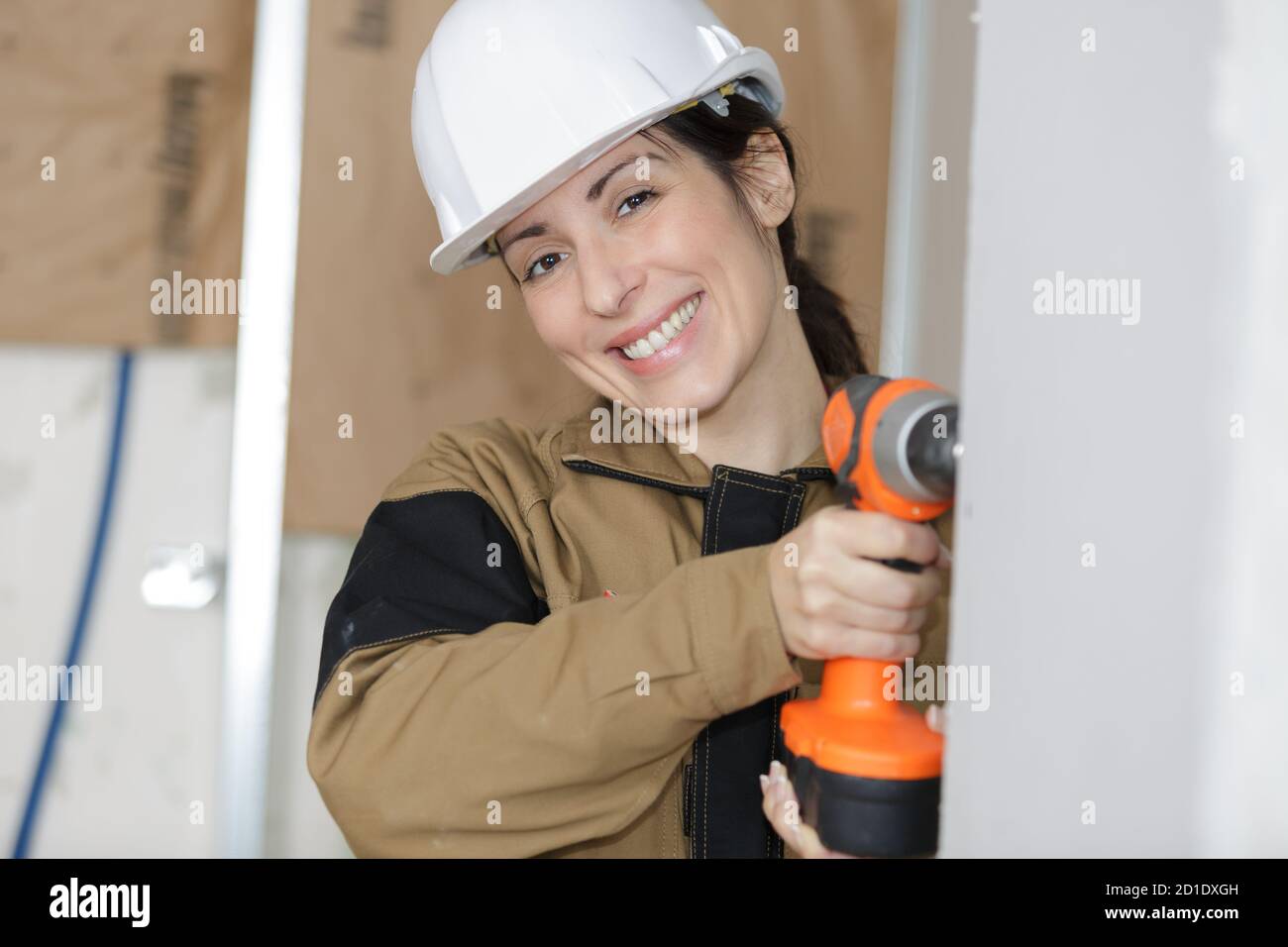 female carpenter at work using hand drilling machine Stock Photo - Alamy