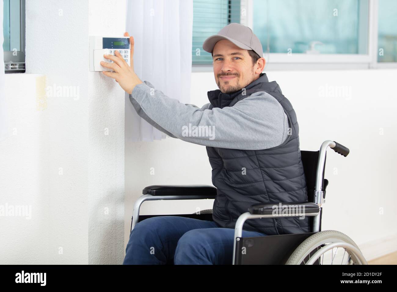 man in wheelchair pressing buttons on electronic keypad Stock Photo - Alamy