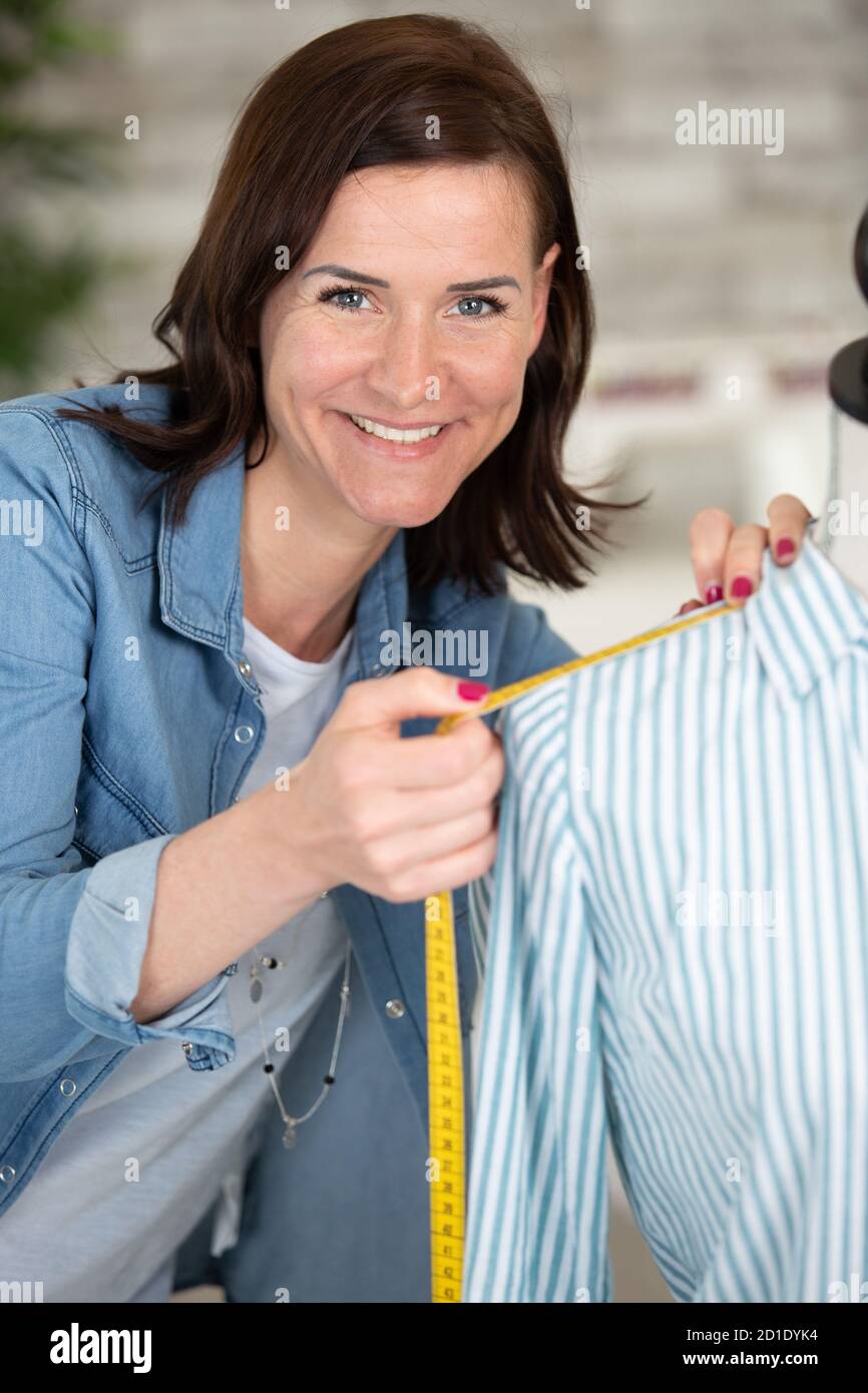 designer at work with fabric measuring cloth Stock Photo - Alamy