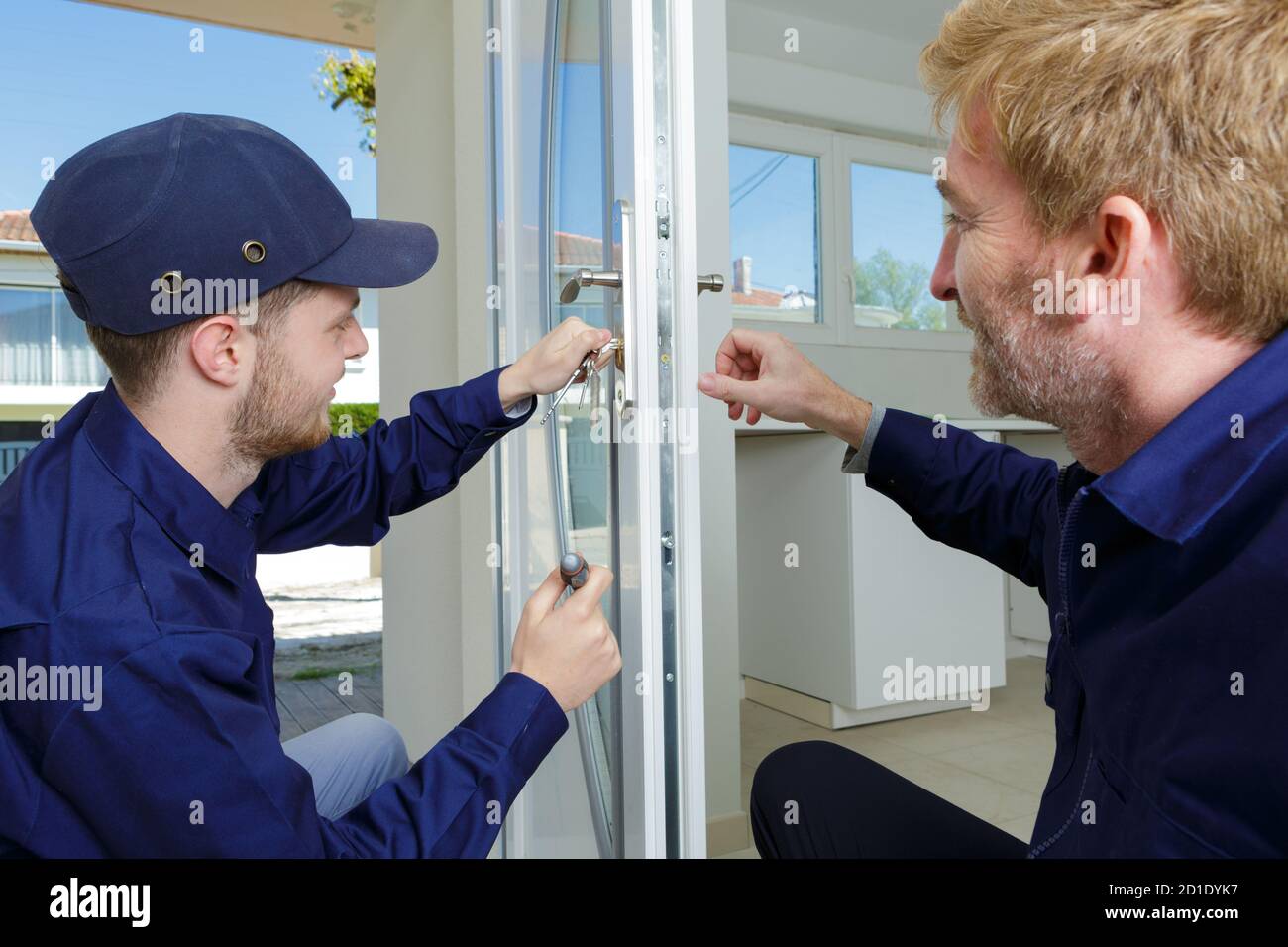 workers fitting a window Stock Photo - Alamy