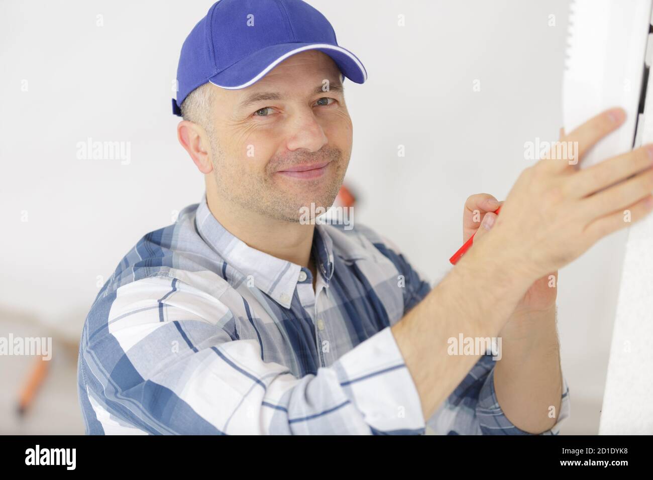 a hvac technician testing thermostat Stock Photo - Alamy