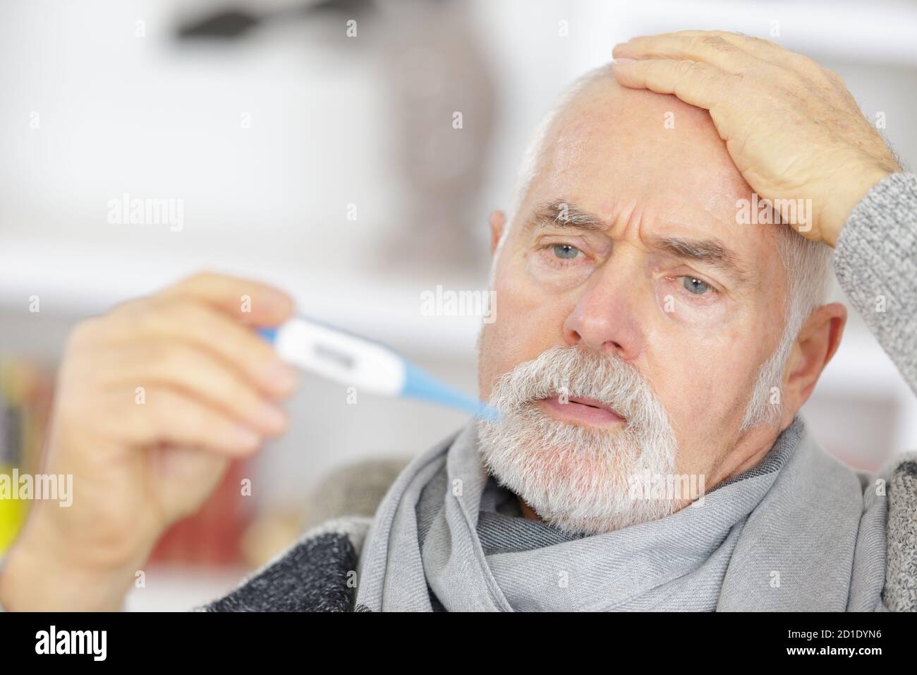 senior man checking body temperature with thermometer Stock Photo - Alamy