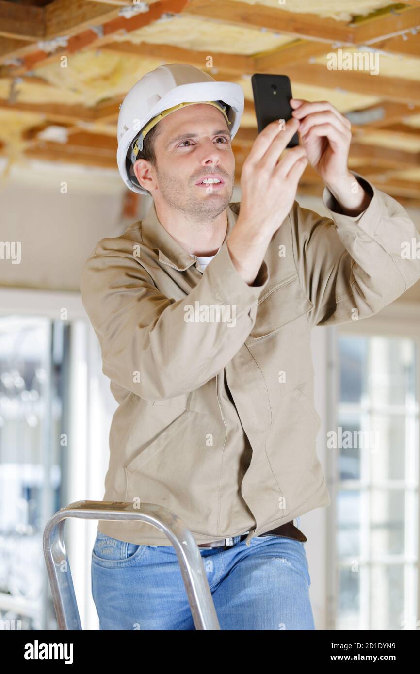 builder man talking pictures of a structure Stock Photo - Alamy
