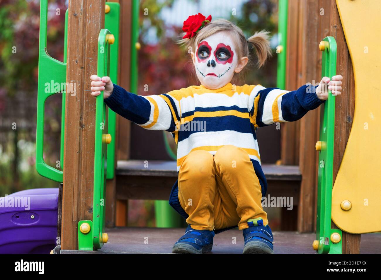 A little girl with Painted Face, shows funny faces on Mexican Day of ...