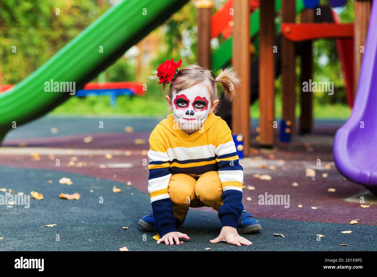 A little girl with Painted Face, smiling at the camera on Day of the ...
