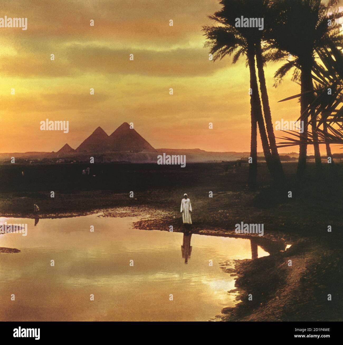 Colorized photo of people near water with the Giza Pyramid Complex in ...