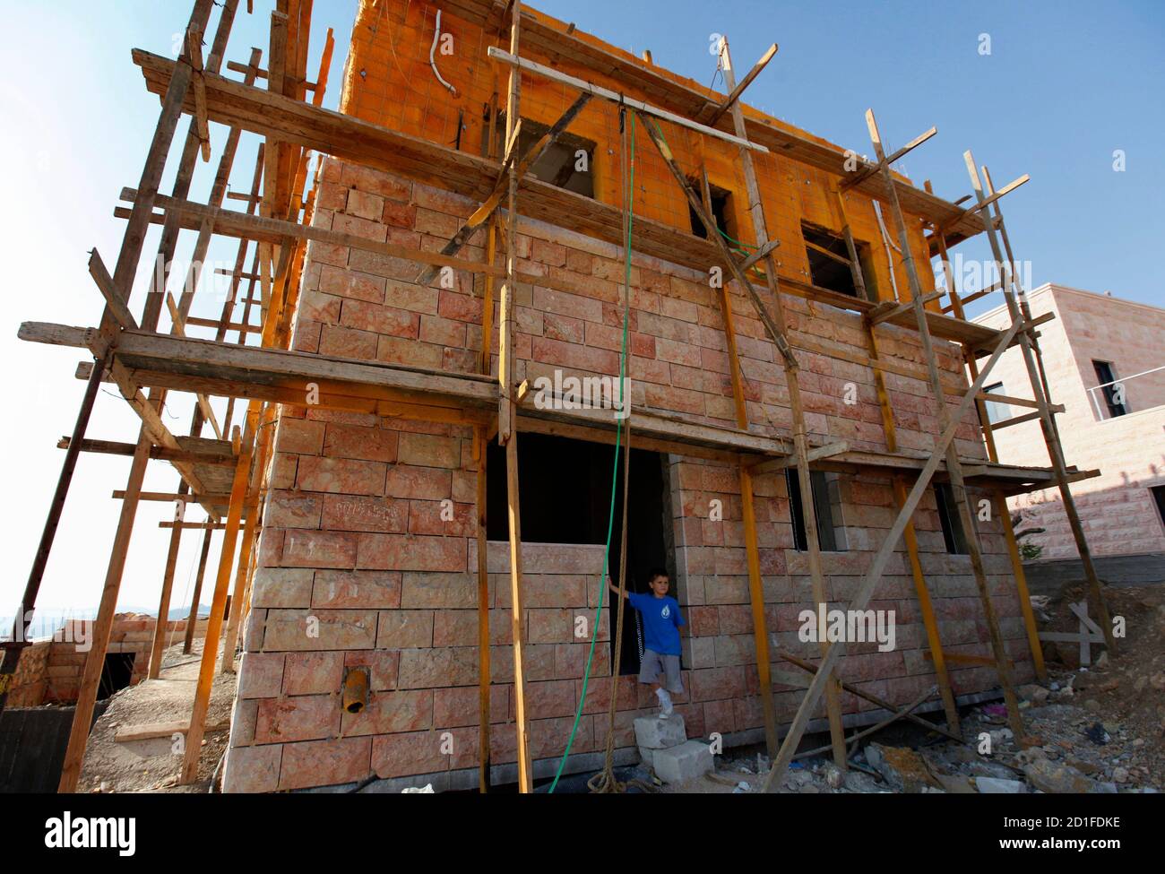 EDITORIAL USE ONLY - NO COMMERCIAL OR BOOK SALES. A boy stands in front ...